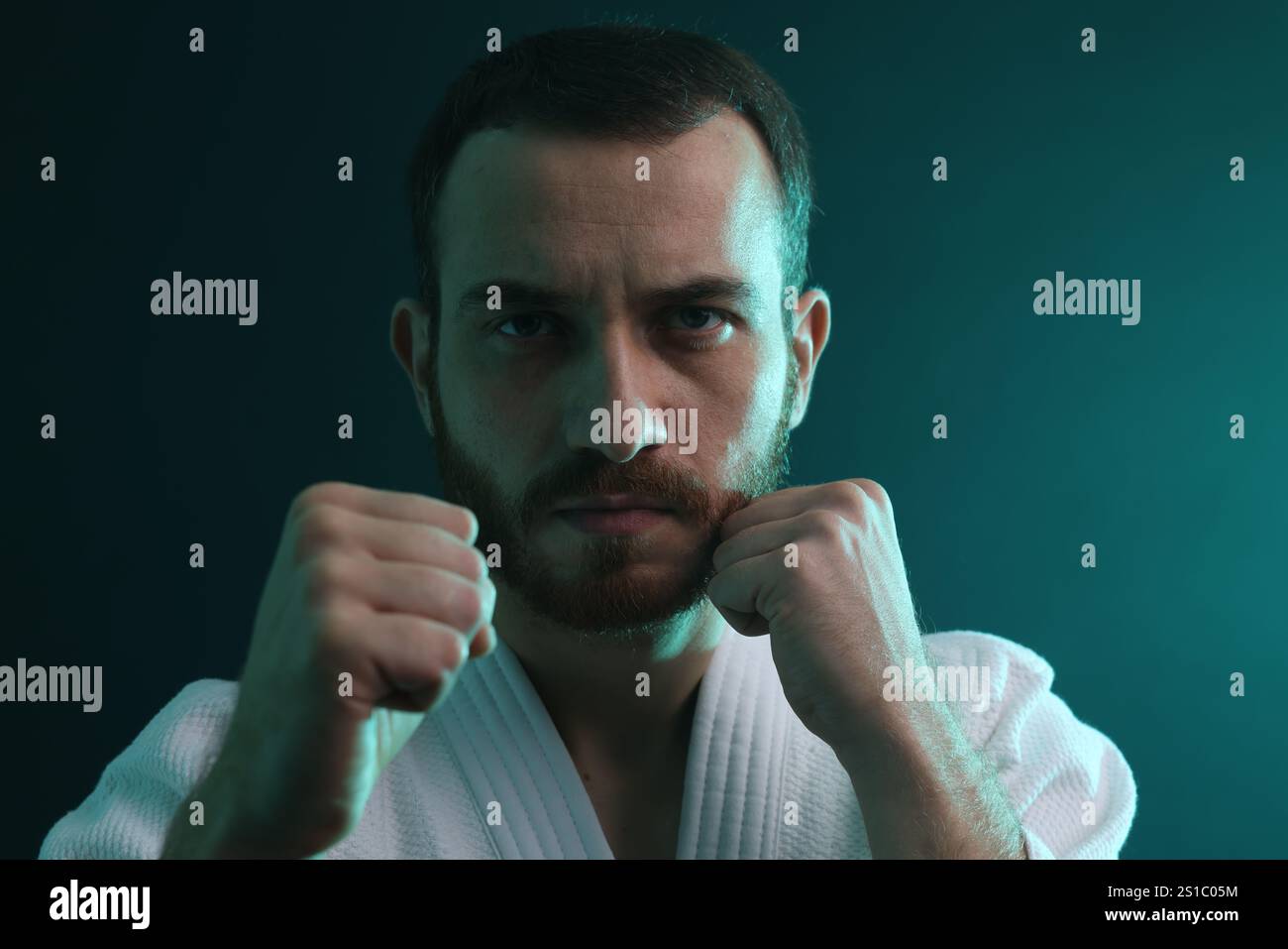 Karate fighter wearing uniform in color lights, closeup Stock Photo - Alamy