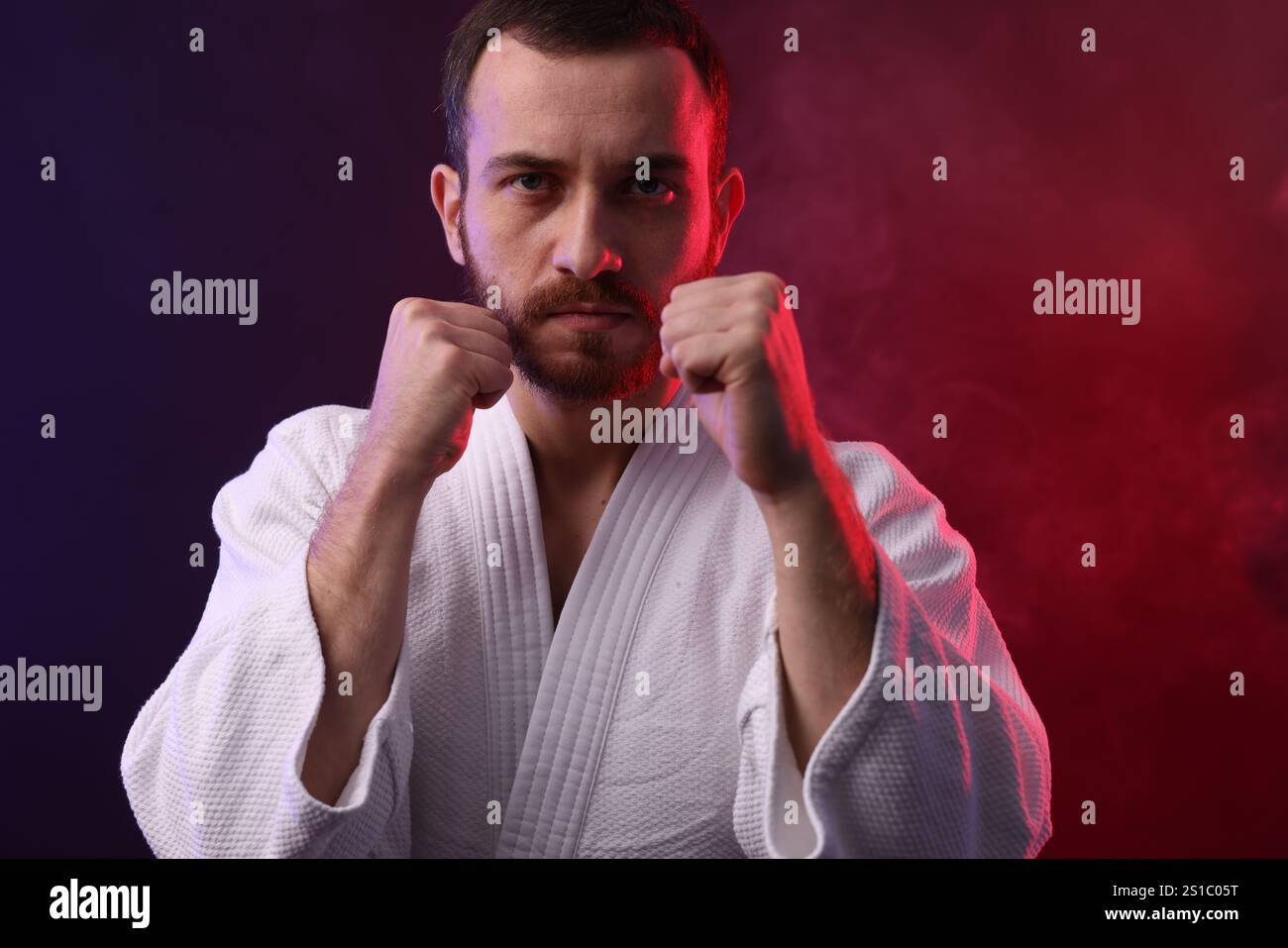Karate fighter wearing uniform in color lights and smoke Stock Photo ...
