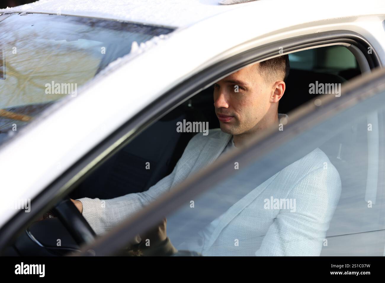 Driver behind steering wheel of modern car, view from outside Stock ...