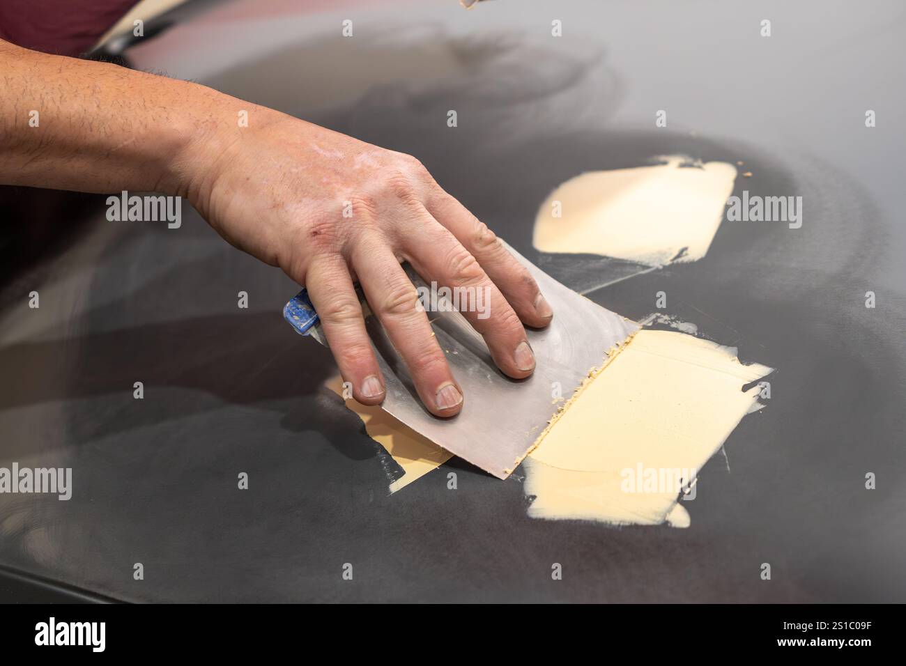 Detailed View of Mechanic Applying Body Filler on Car Stock Photo - Alamy