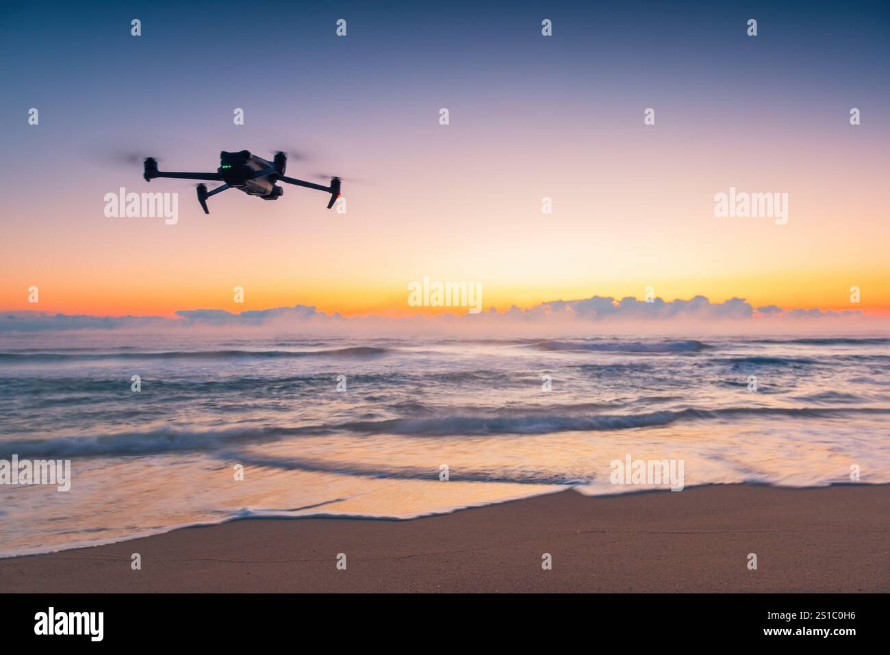 Drone Over Ocean Waves at Sunset Under Vibrant Sky Stock Photo - Alamy