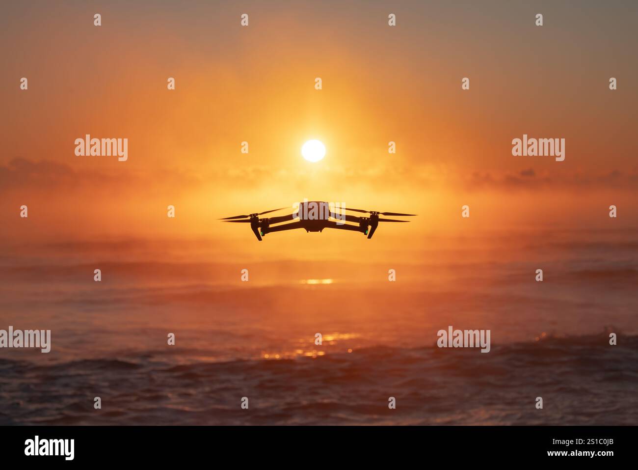 Flying Drone Over Ocean Horizon During Vibrant Sunset Stock Photo - Alamy