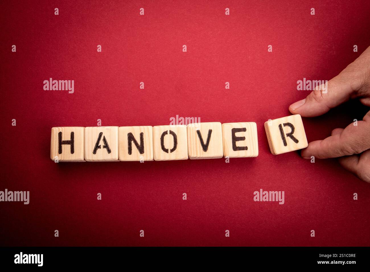 HANOVER. Word from wooden alphabet blocks on a red background Stock ...