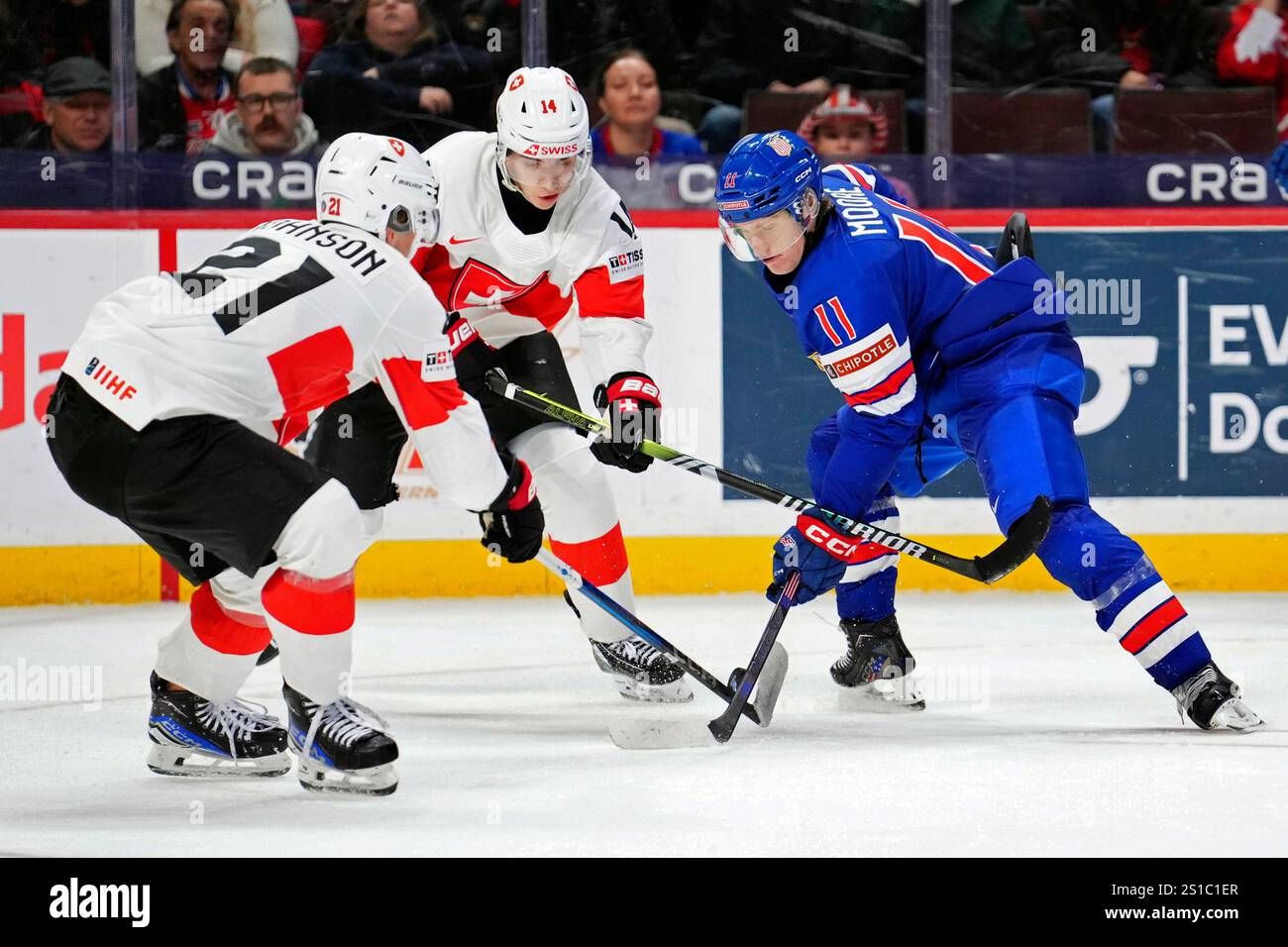 Switzerland defensemen Ludvig Johnson (21) and Nils Rhyn (14) battle ...