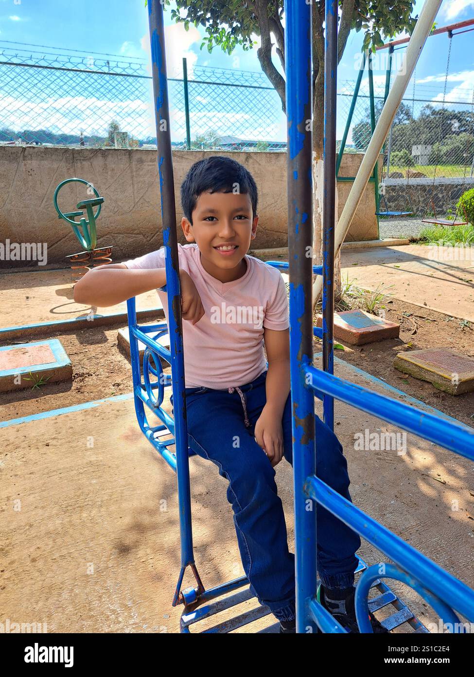 9-year-old dark-skinned Latino male child practices balance exercises ...