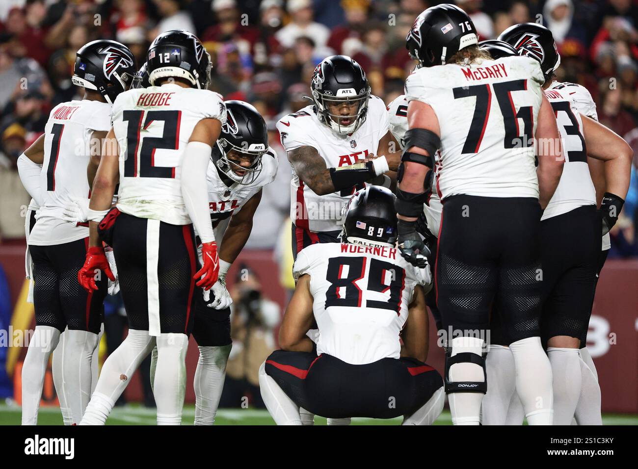 Atlanta Falcons players huddle up during an NFL football game against ...