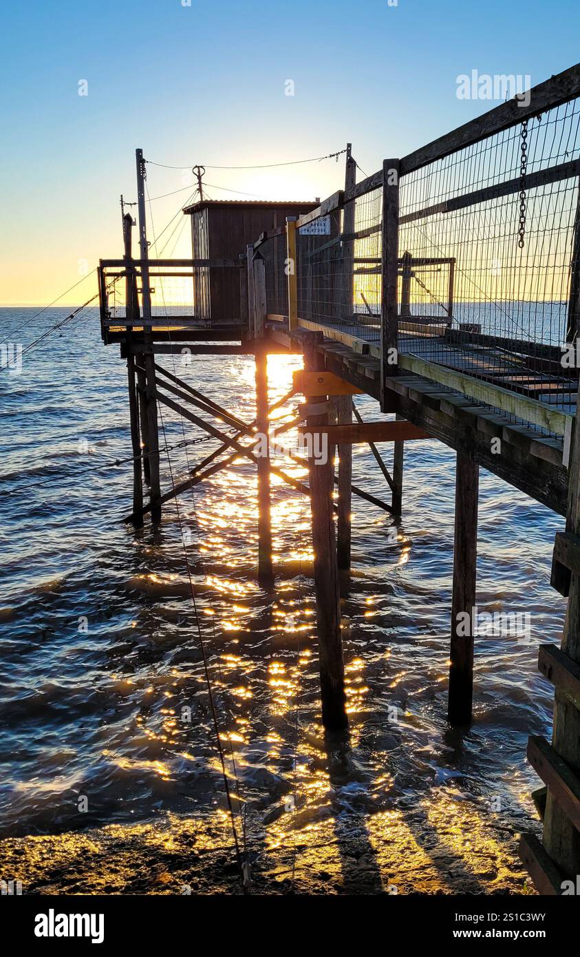 Traditional old wooden fishing huts on stilts in the Atlantic Ocean ...
