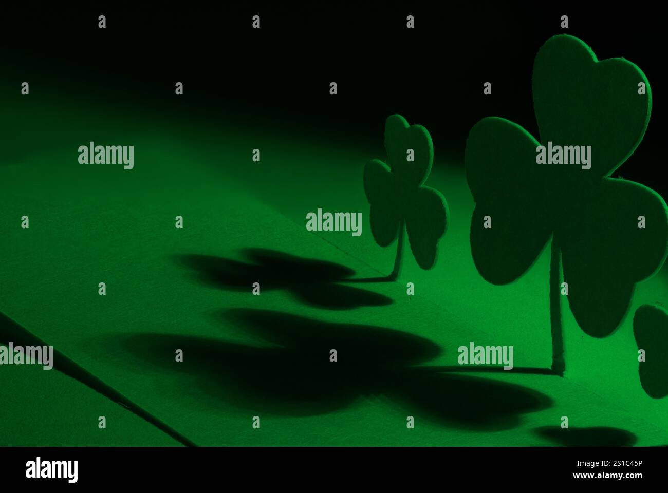 Two shamrocks bathed in green light at an oblique angle Stock Photo - Alamy