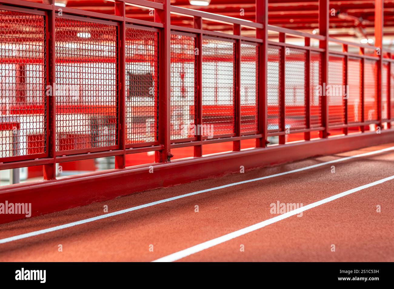 Close-up photo of the red railing along an elevated indoor running ...