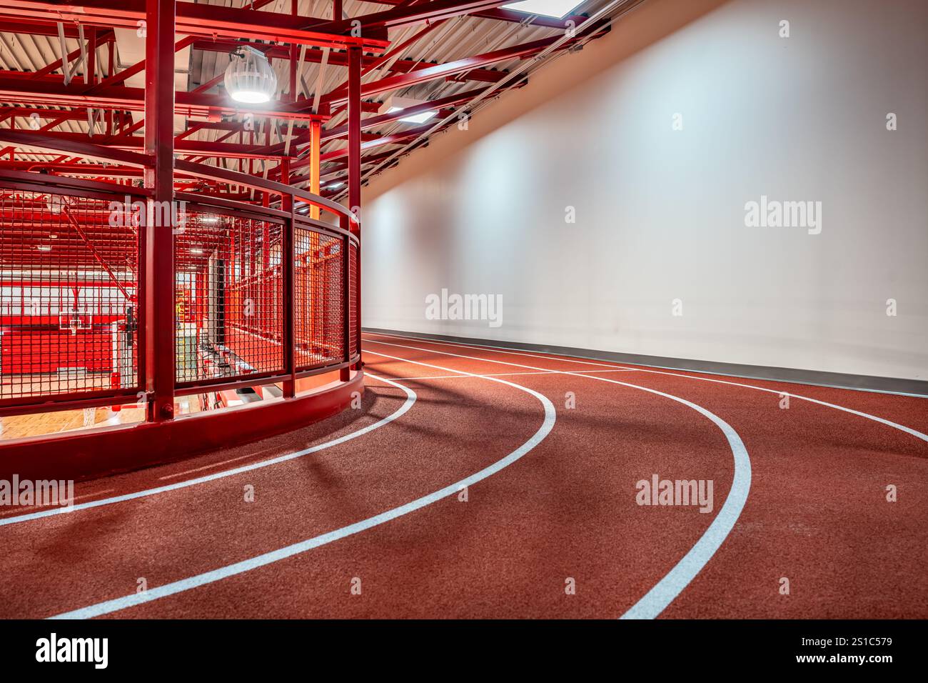 Close-up photo of the red railing along an elevated indoor running ...