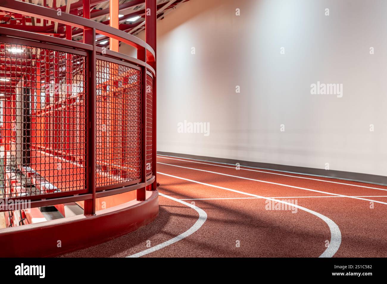 Close-up photo of the red railing along an elevated indoor running ...