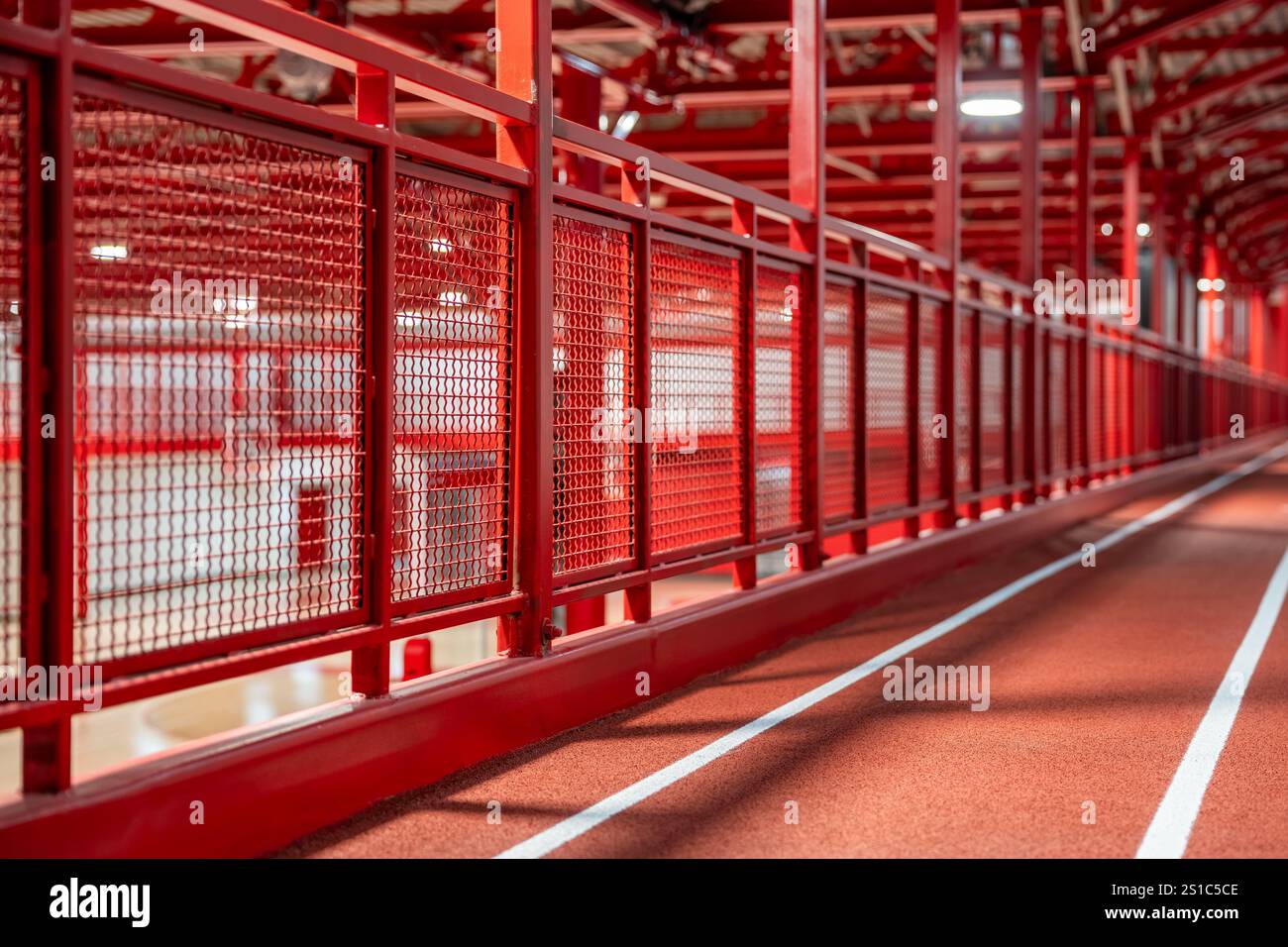 Close-up photo of the red railing along an elevated indoor running ...