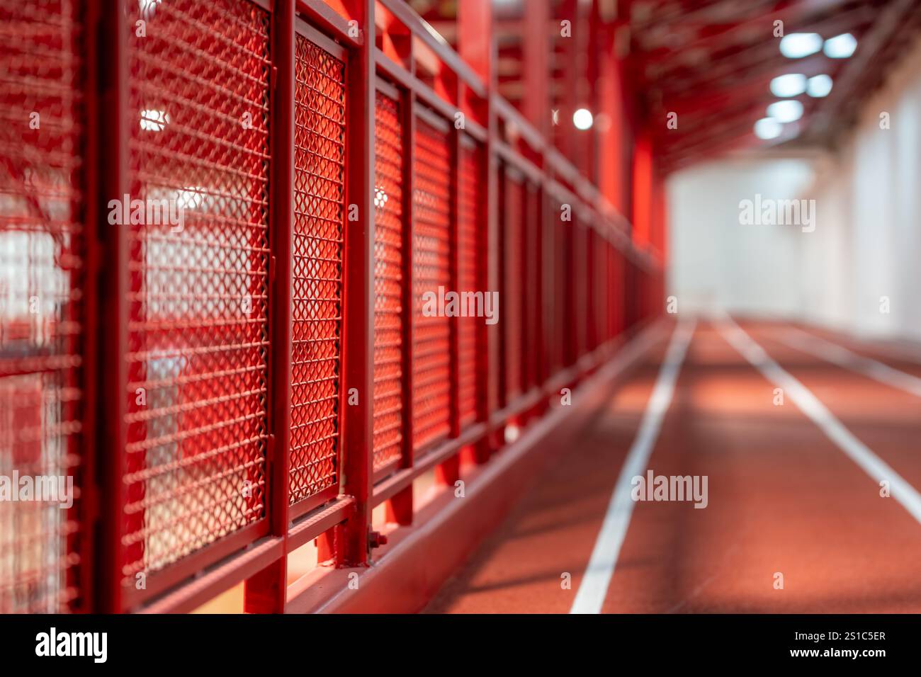 Close-up photo of the red railing along an elevated indoor running ...