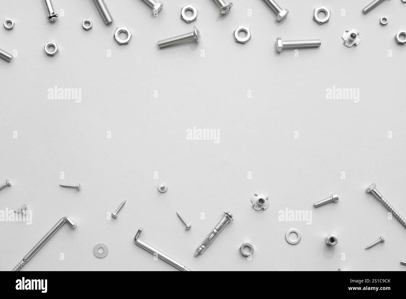 Different tap bolts, screws and chrome nuts on grey background Stock ...