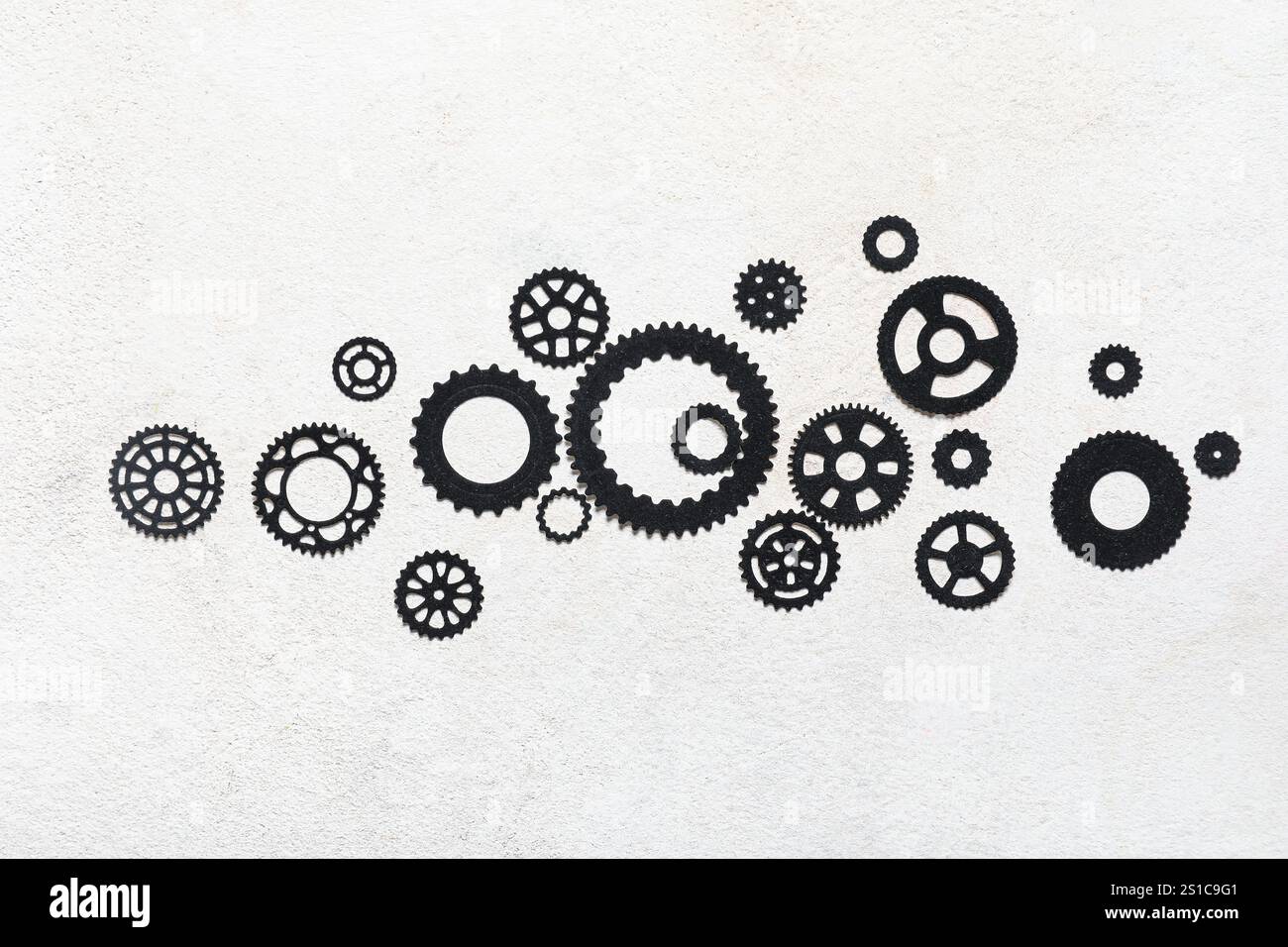 Black paper gears on white background Stock Photo - Alamy