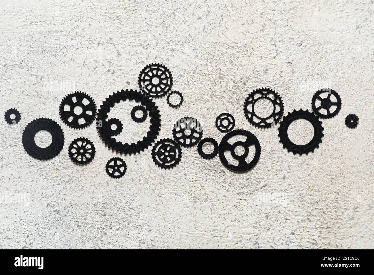 Black paper gears on white background Stock Photo - Alamy