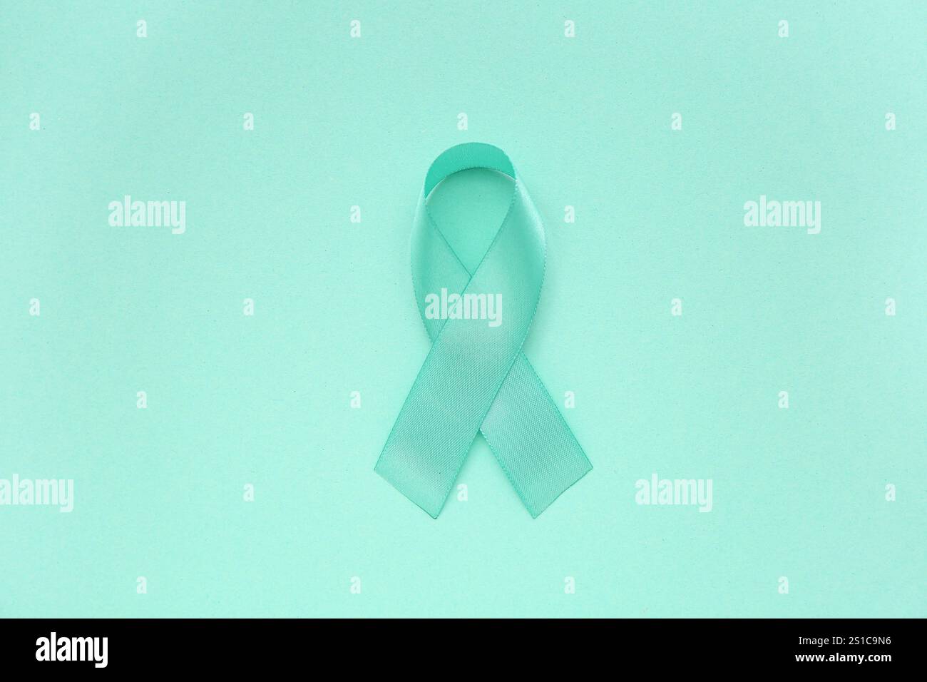 Turquoise ribbon on color background. Cervical Health Awareness Month ...