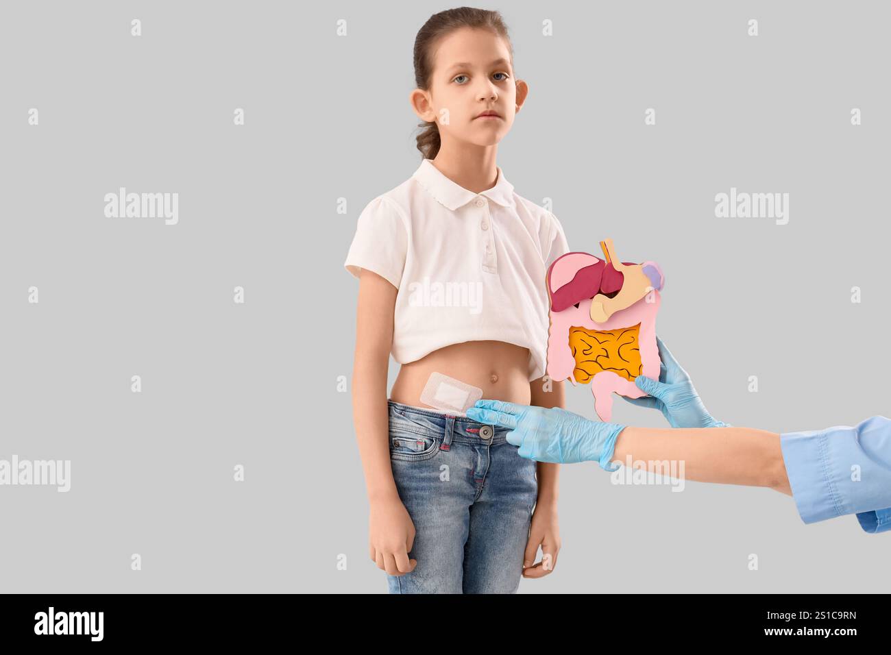 Teenage girl after appendectomy surgery and doctor with paper digestive ...