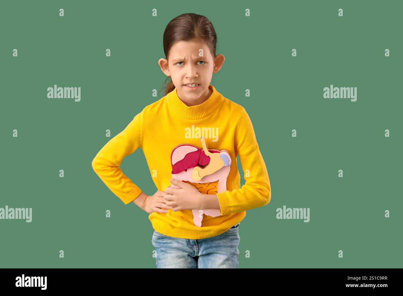 Teenage girl with appendicitis and paper digestive system on green ...