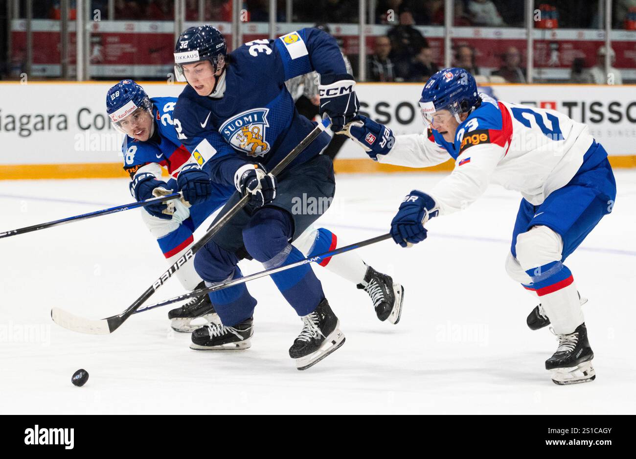 Finland forward Emil Hemming (32) is pressured by Slovakia defenseman ...
