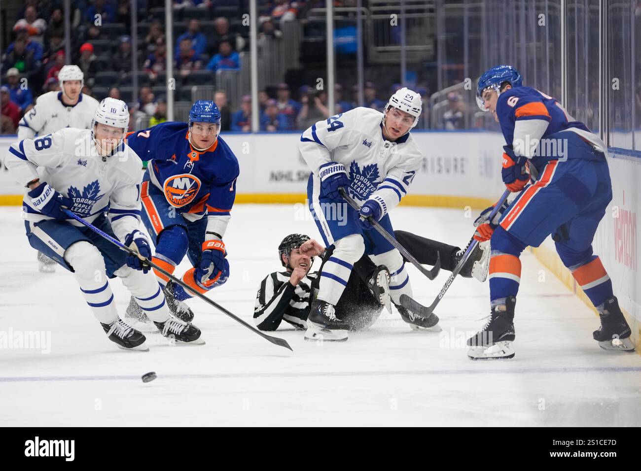 Toronto Maple Leafs' Connor Dewar (24) fights for control of the puck ...