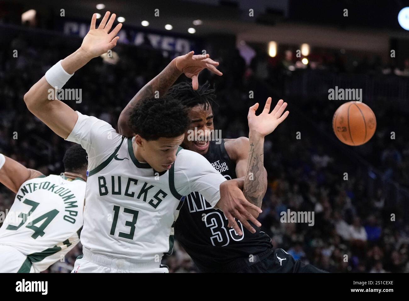 Milwaukee Bucks' Ryan Rollins and Brooklyn Nets' Nic Claxton go after a ...