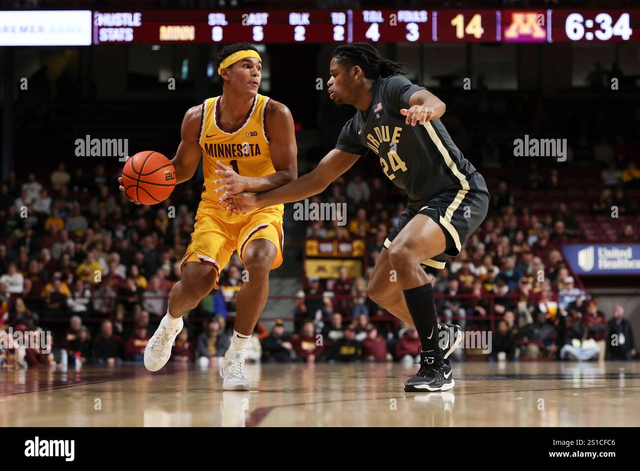 Minnesota guard Isaac Asuma (1) dribbles up the court as Purdue guard ...