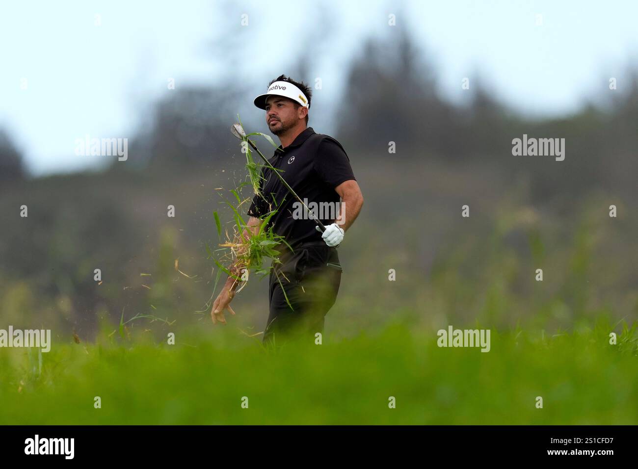 Jason Day, of Australia, hits out of the rough on the 12th fairway ...