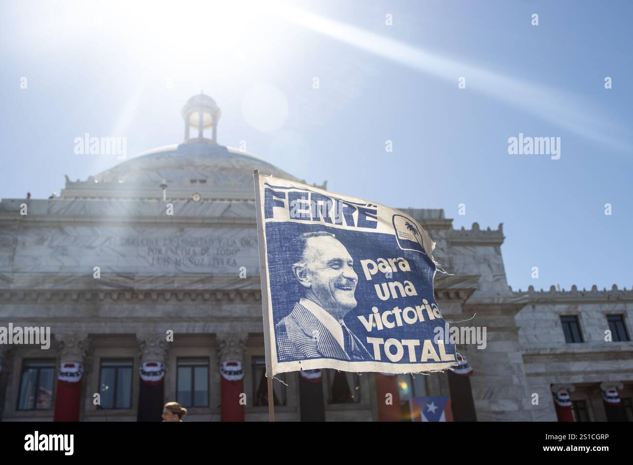 A man waves a flag of Luis A. Ferré Aguayo, former governor of Puerto ...