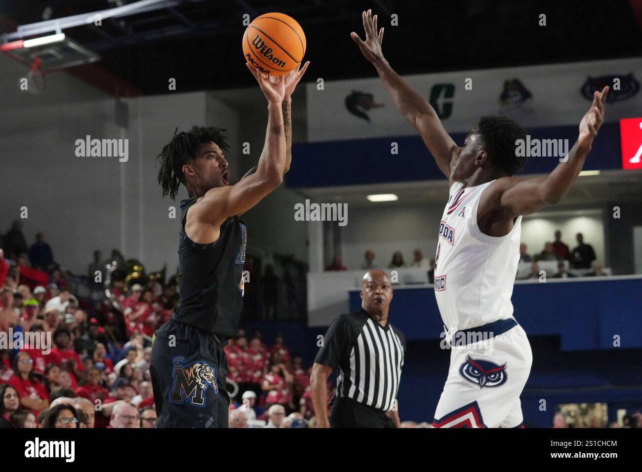 Memphis guard PJ Haggerty (4) aims a three point shot as Florida ...