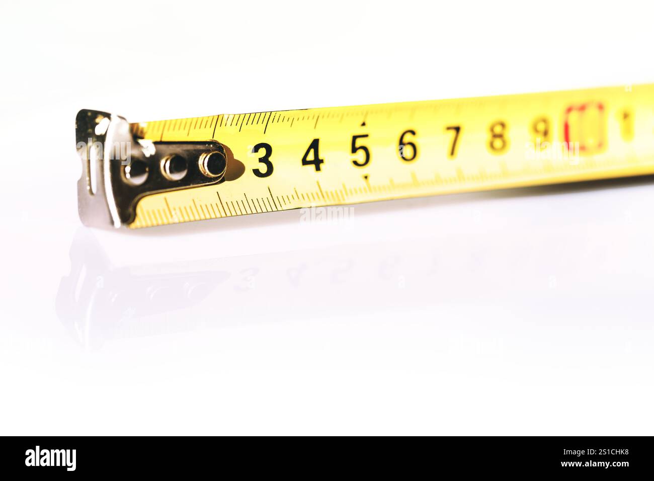 View of a yellow measuring tape with black numbers and markings ...