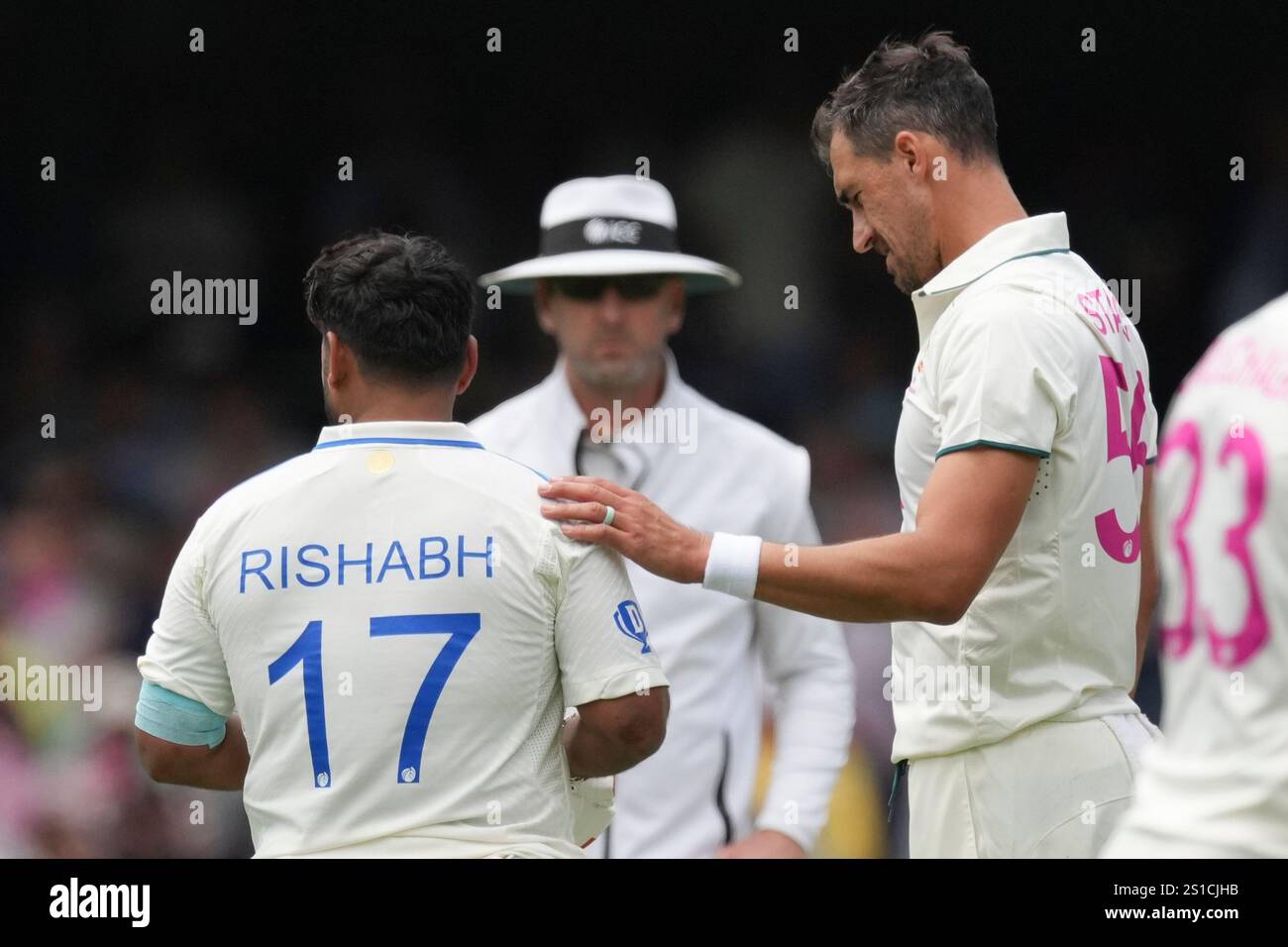 Australia's Mitchell Starc checks on India's Rishabh Pant, left, during ...