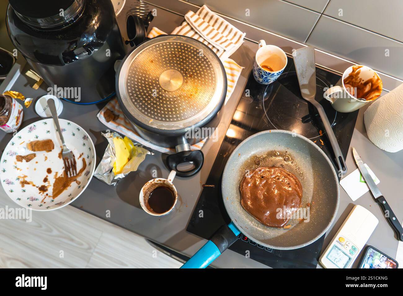 Messy Kitchen with Pancakes and Coffee Spills Stock Photo - Alamy