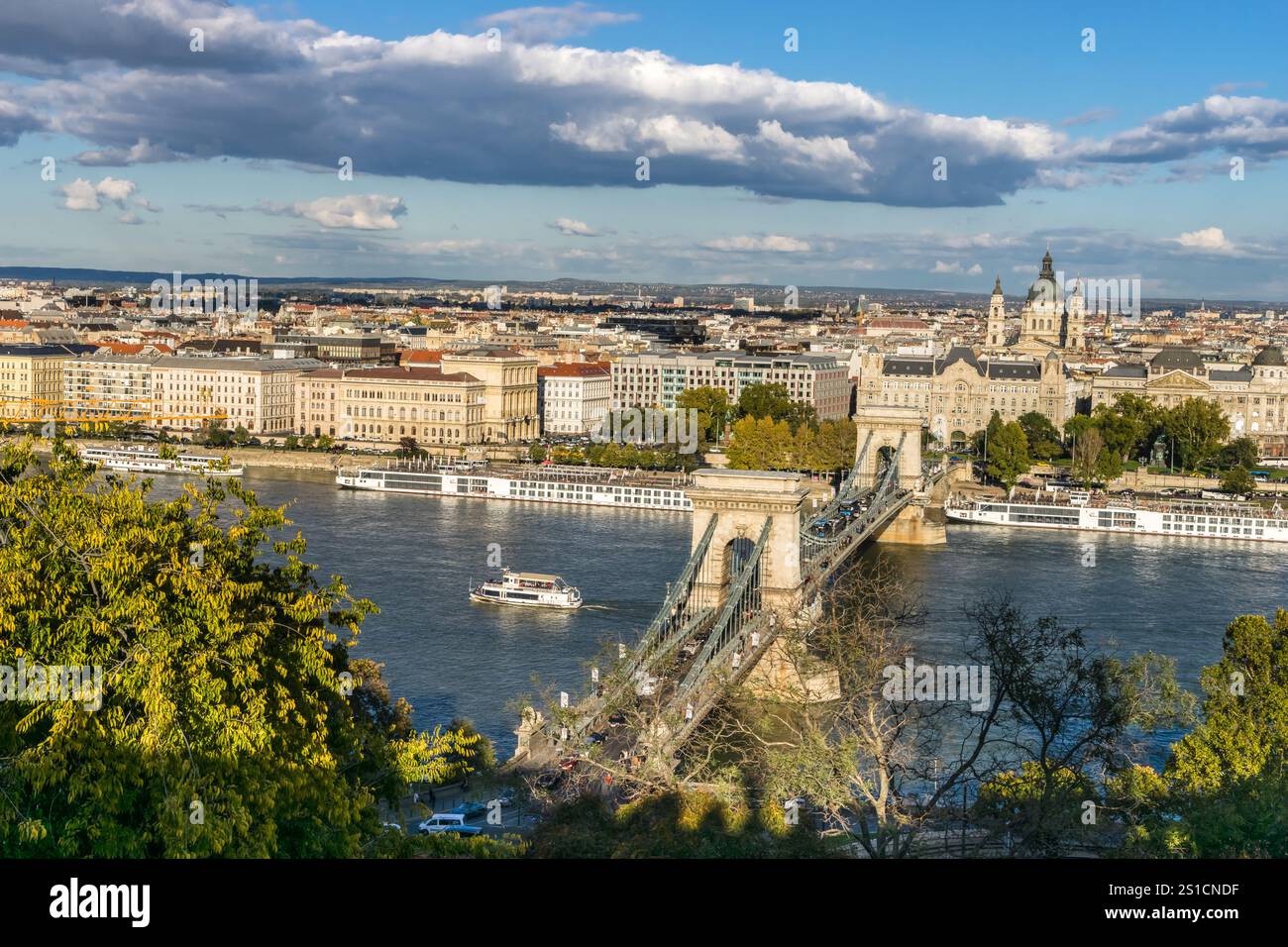 View to Chain Bridge and city Pest with blue sky and dark clouds background, Budapest, Hungary ...