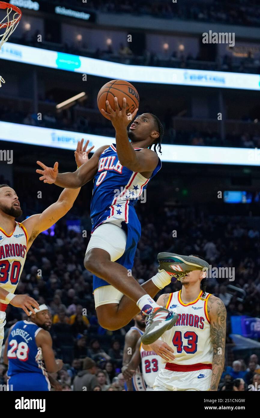 Philadelphia 76ers guard Tyrese Maxey, center, shoots while defended by ...