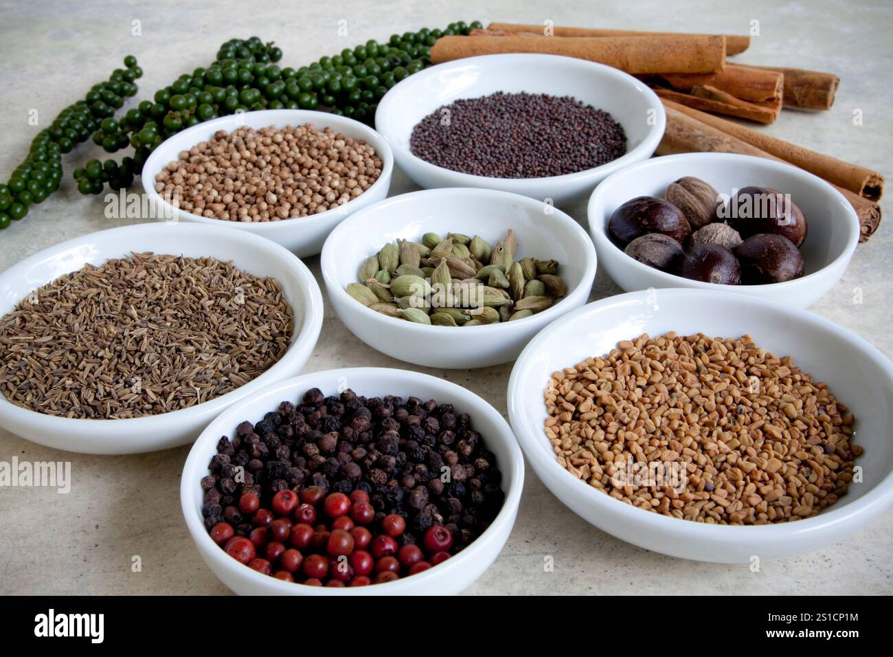 An assortment of fresh Indian and Sri Lankan spices in white bowls ...