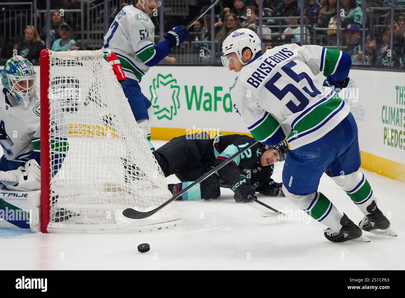 Vancouver Canucks defenseman Guillaume Brisebois (55) clears the puck ...