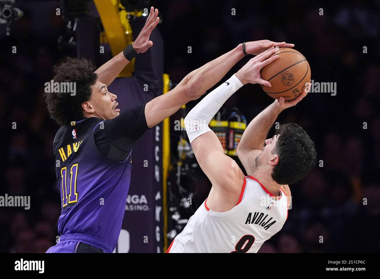 Portland Trail Blazers forward Deni Avdija, right, shoots as Los Angeles Lakers center Jaxson ...