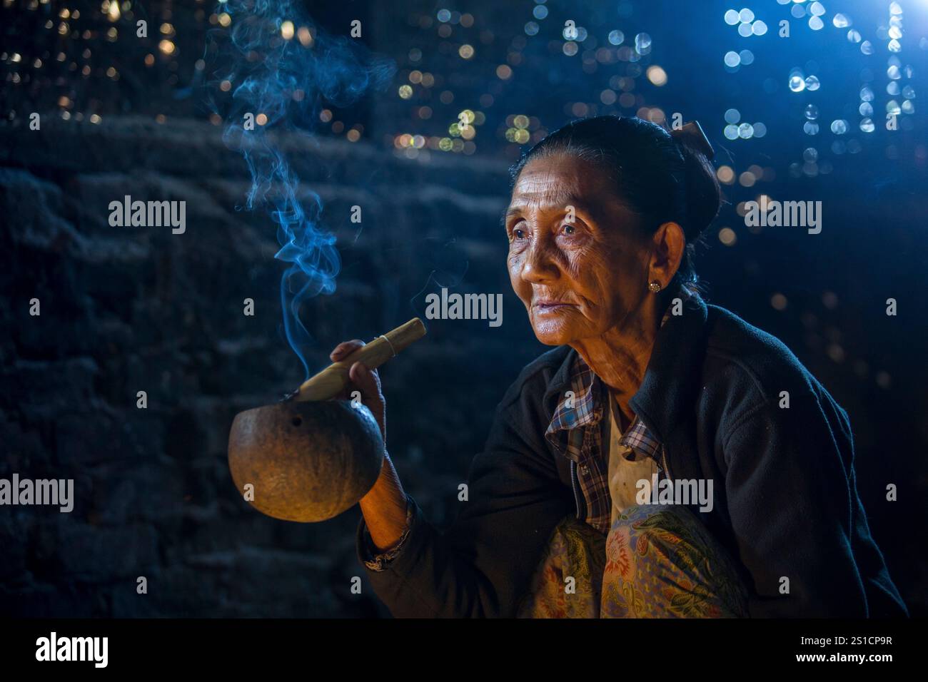 Smoking old lady in kitchen, Old Bagan, Nyaung U, Myanmar Stock Photo ...