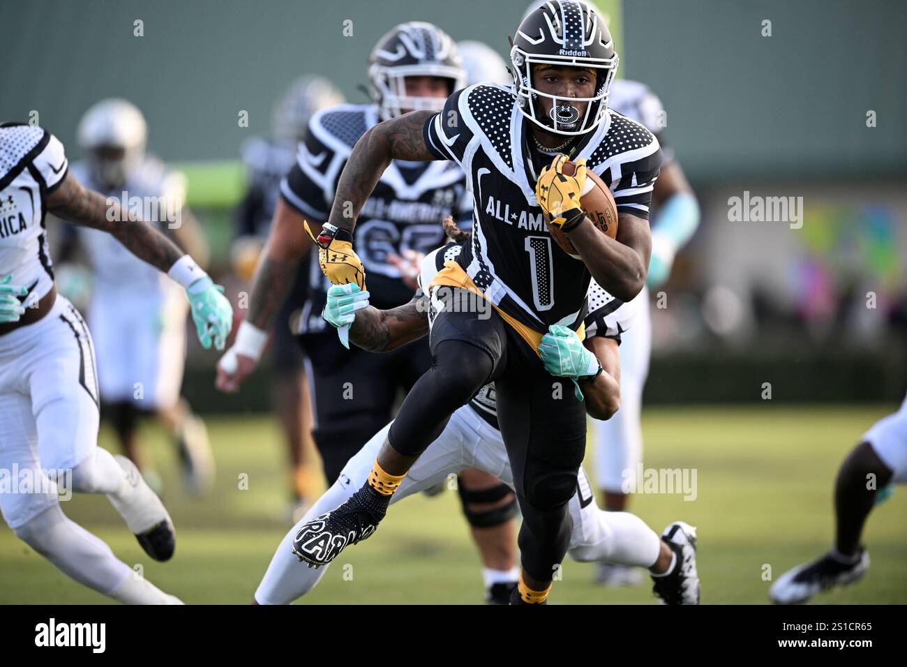 Team Icon receiver Dakorien Moore (1) is tackled by Team Unstoppable ...