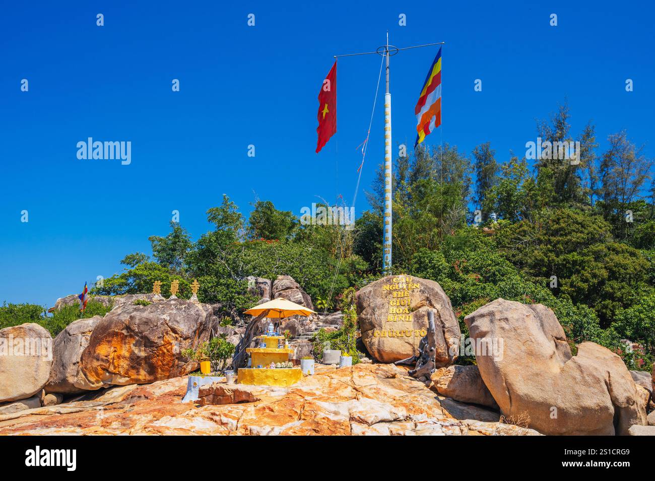 Flagpole with the flag of Vietnam on the island with the Tu ton pagoda ...