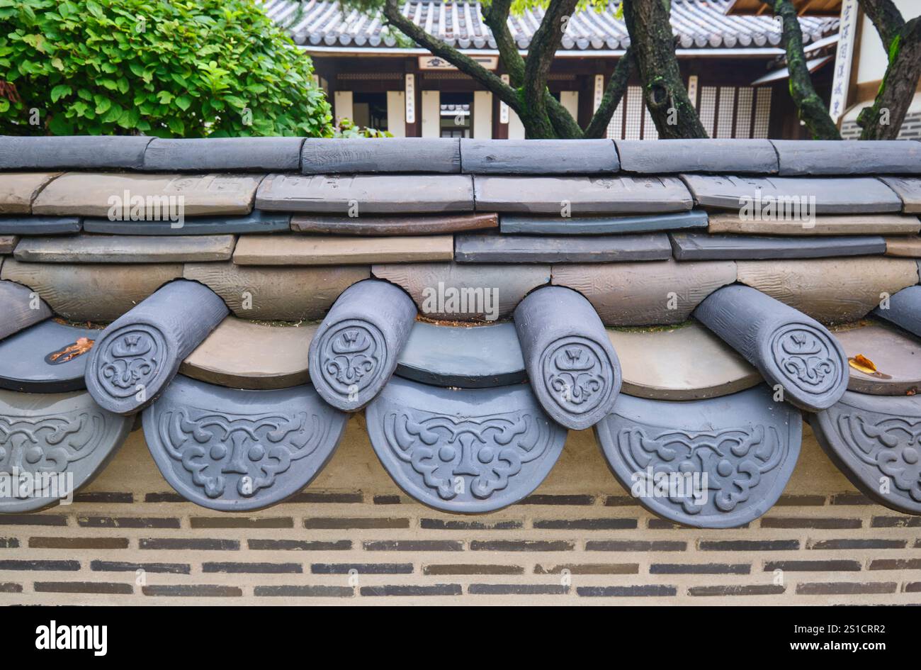 Detail of the grey, barrel roof tile, embossed and lining a wall. At ...