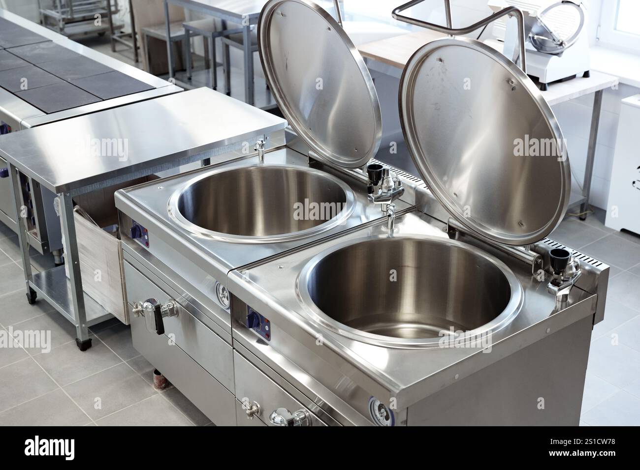 Stainless steel cooking equipment in a modern kitchen for meal ...