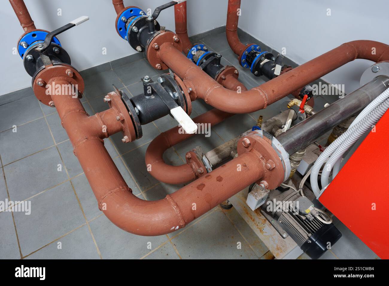 Pipes and valves in a mechanical room showcase a complex plumbing ...
