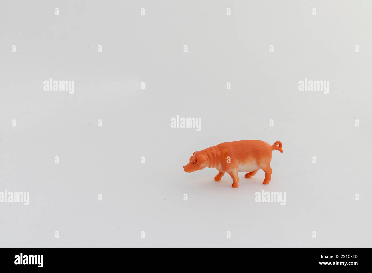 Miniature plastic pig toy isolated on white background Stock Photo - Alamy