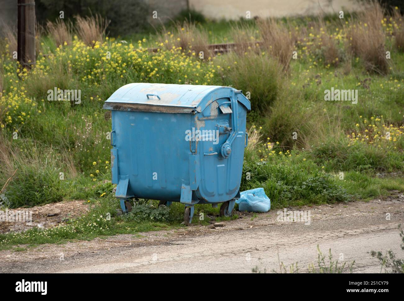 Blue garbage bin and uncollected Waste Stock Photo - Alamy