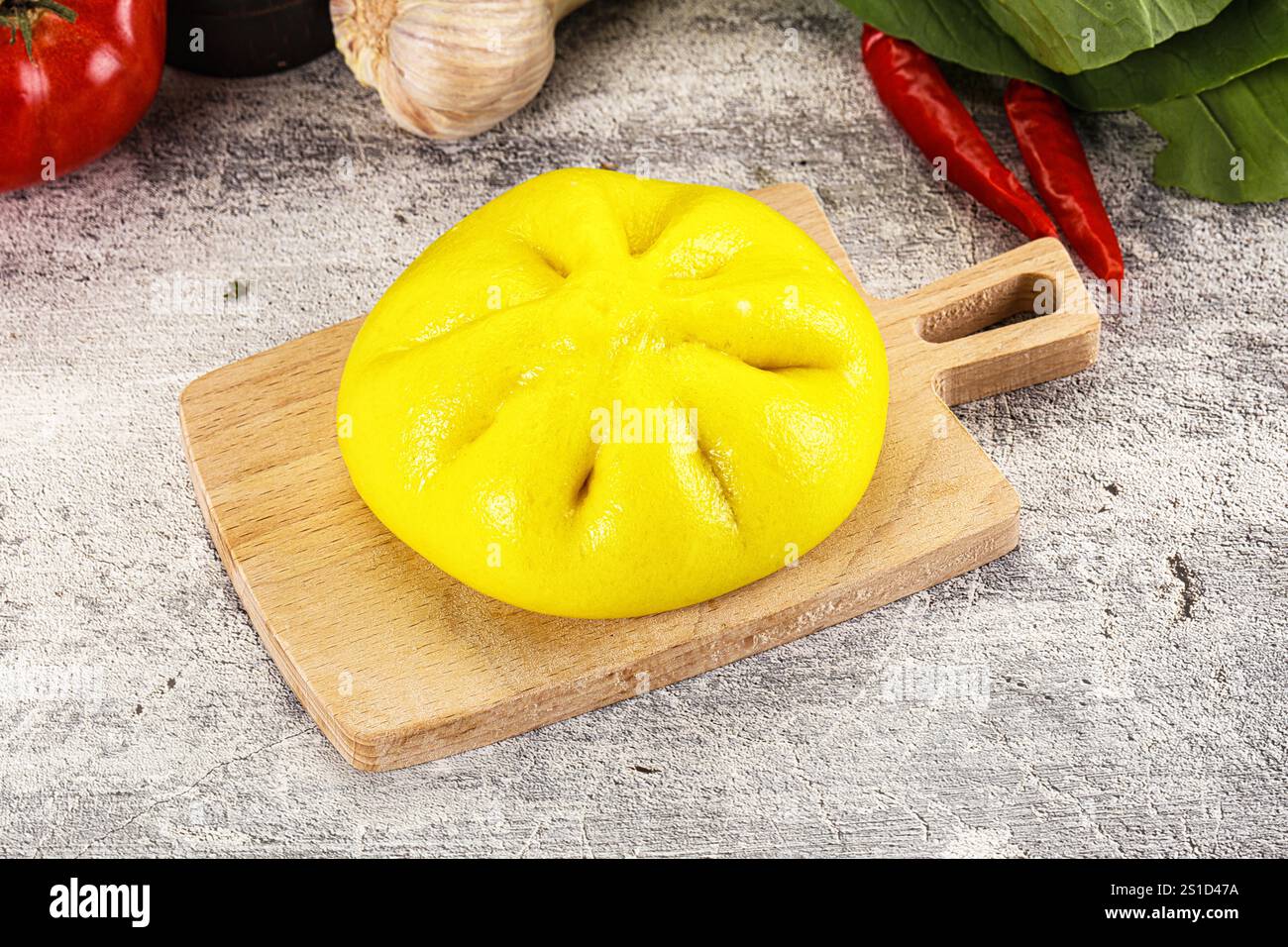 Asian stuffed steamed yellow Bun Bao Stock Photo - Alamy