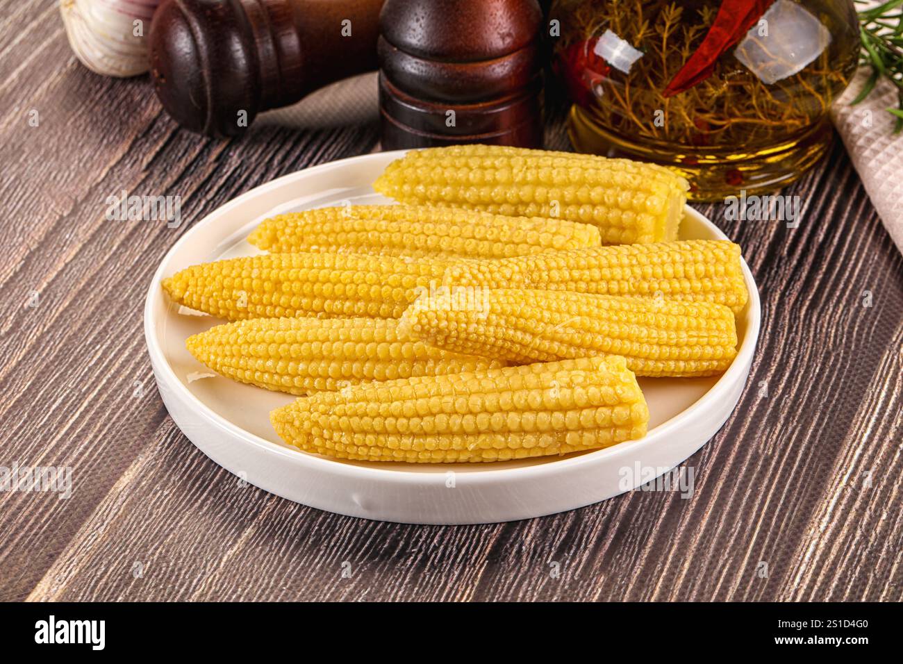 Canned baby mini corn cob in the plate Stock Photo - Alamy