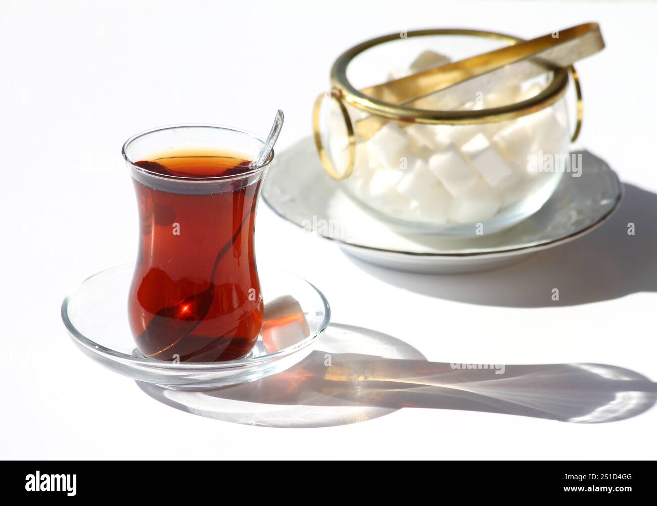 Glass of Turkish Black Tea and Bowl of Sugar Cubes isolated on white ...