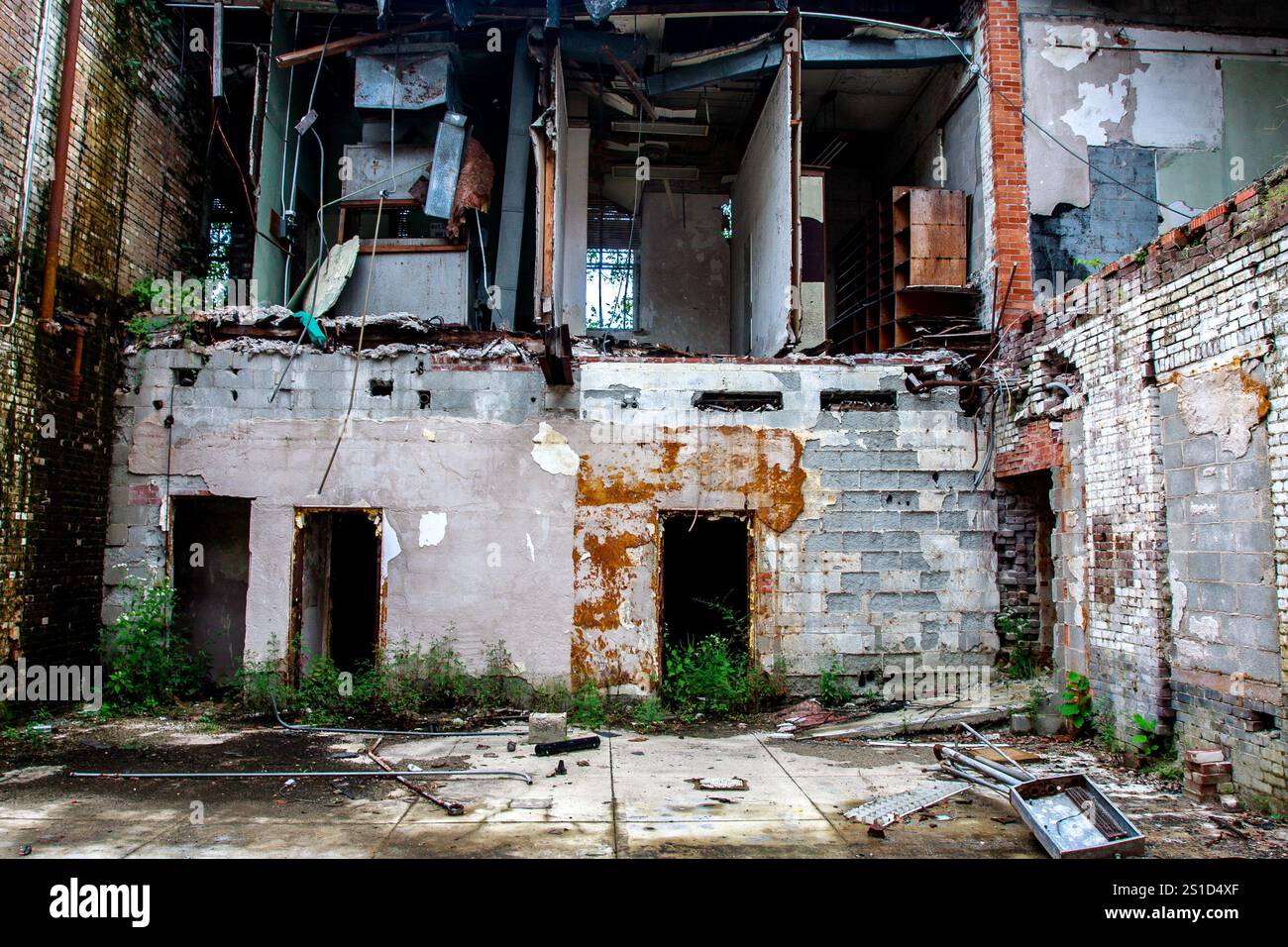 Dilapidated interior of an old building with exposed walls, debris, and ...